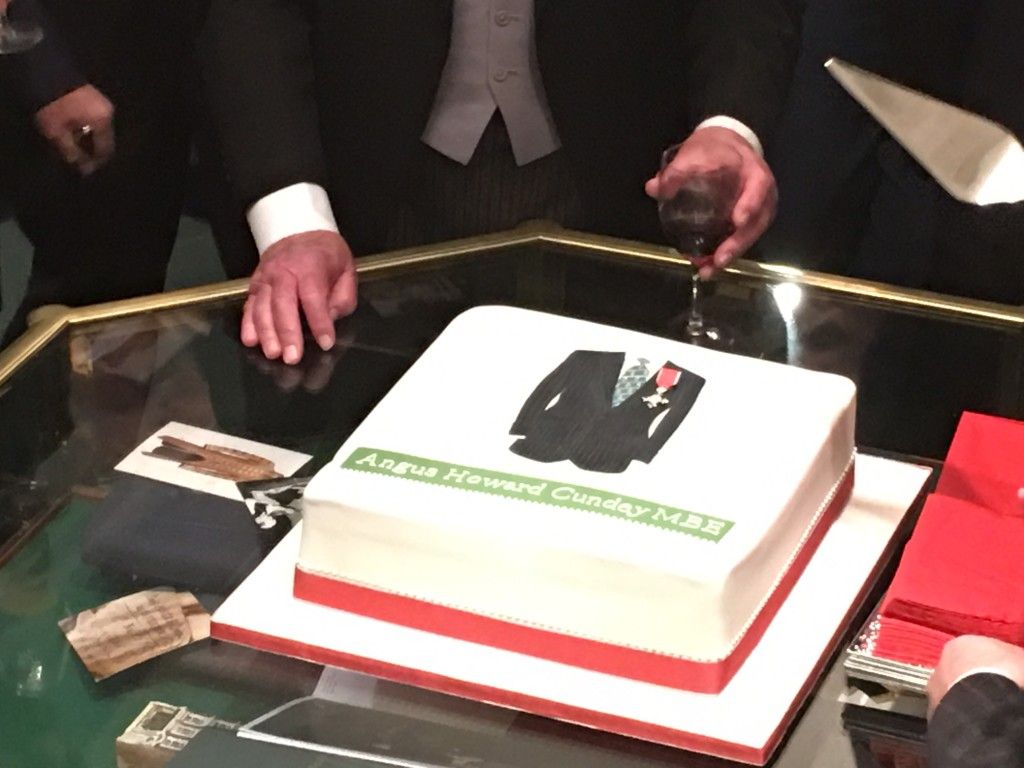 Angus Cundey presented his MBE medal by The Queen - Henry Poole Savile Row